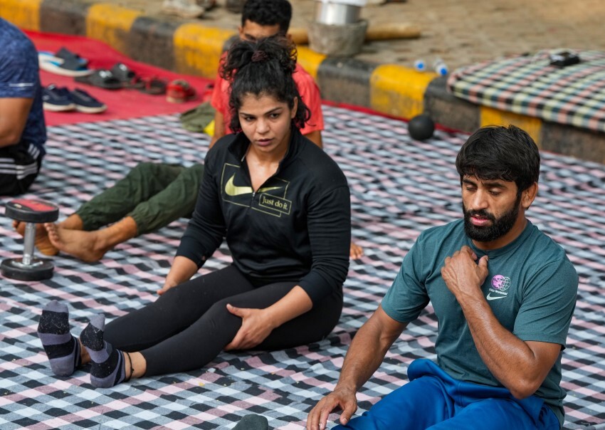 Wrestlers Vinesh Phogat and Sakshi Malik exercise near Jantar Mantar ...